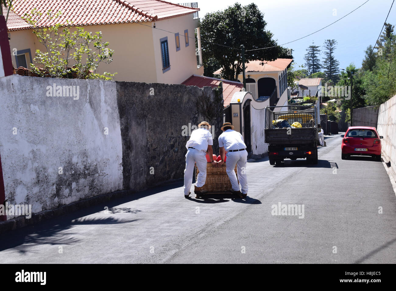 Tourists traveling down the toboggan basket ride, Madeira Stock Photo ...