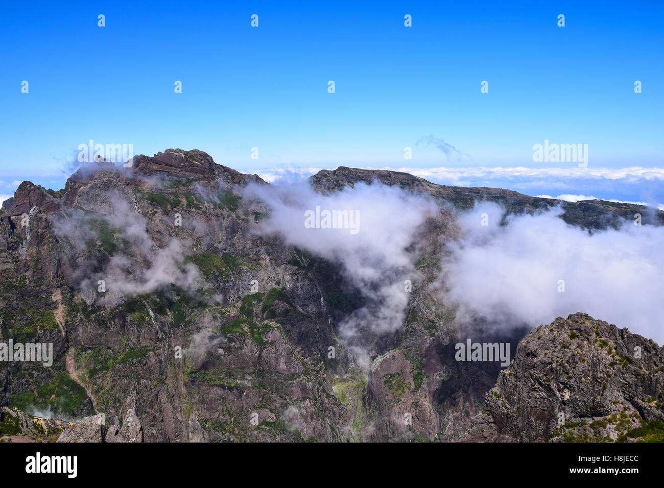 Clouds disappearing into mountains Stock Photo - Alamy