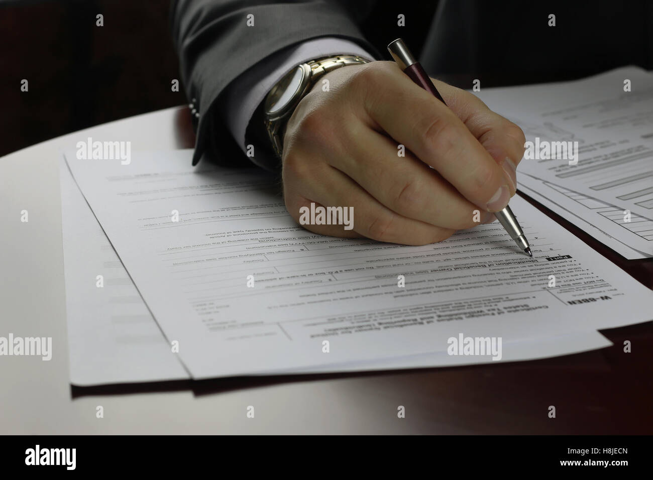 hand signed tax form Stock Photo - Alamy