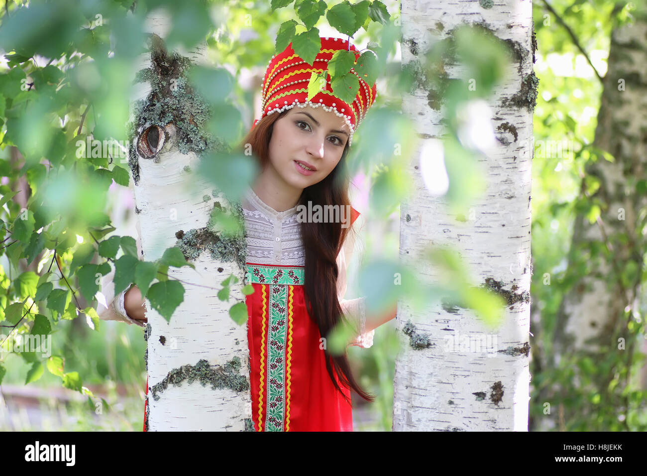 Slav in traditional dress hiding behind trees Stock Photo - Alamy