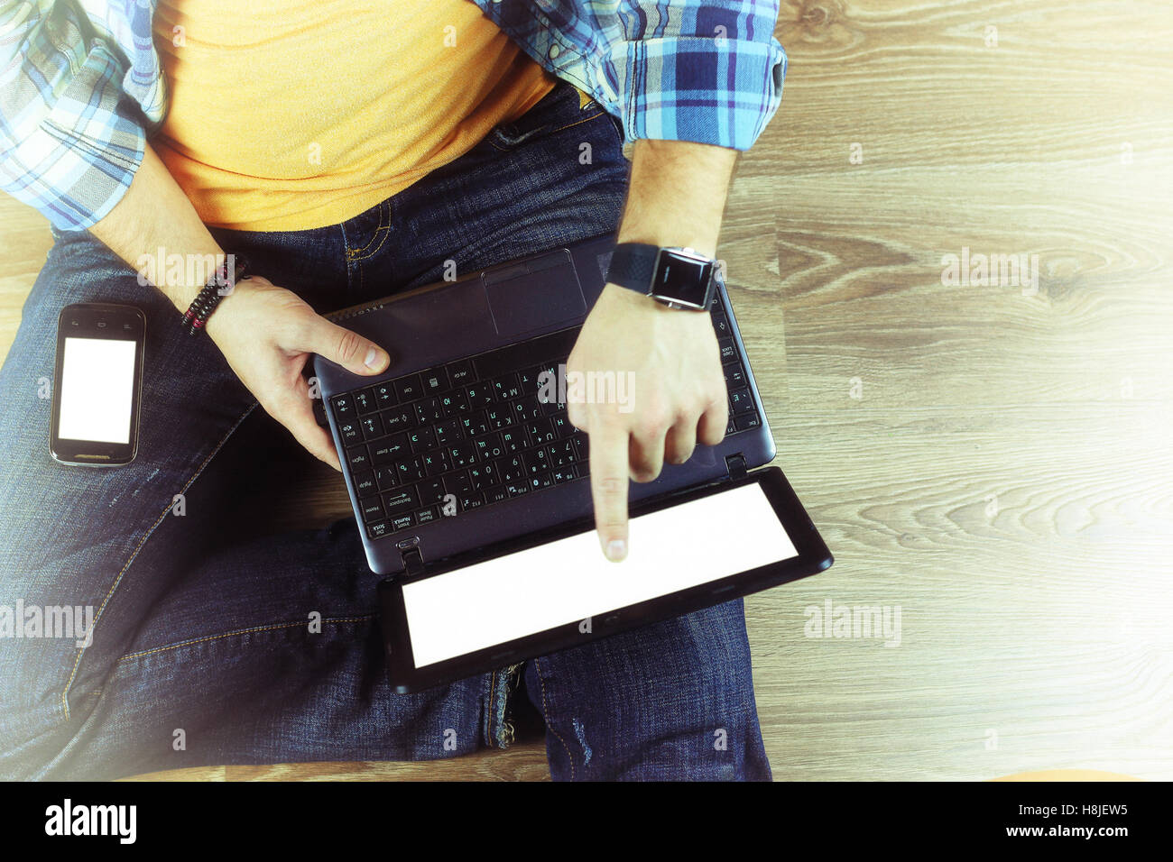 man on the floor with a laptop Stock Photo - Alamy