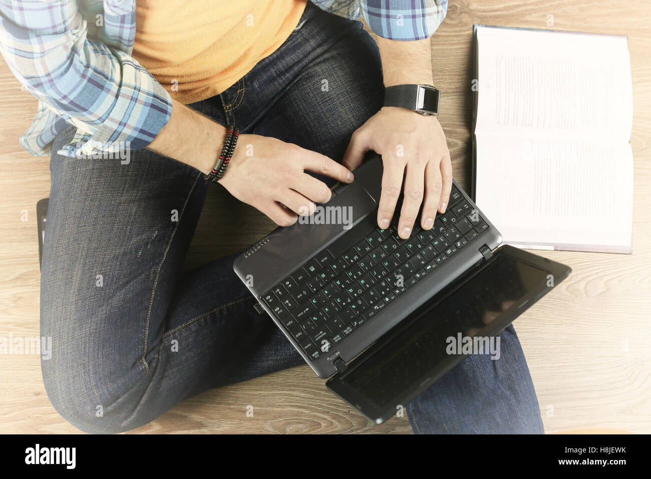 man on the floor with a laptop Stock Photo - Alamy