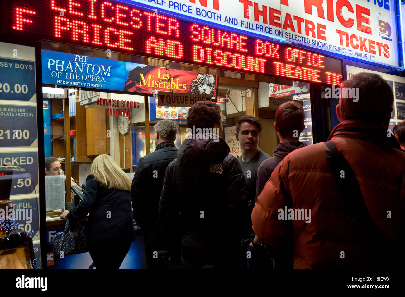 Tourists and visitors in line at a West End show tickets discount store in Leicester Sq. London ...