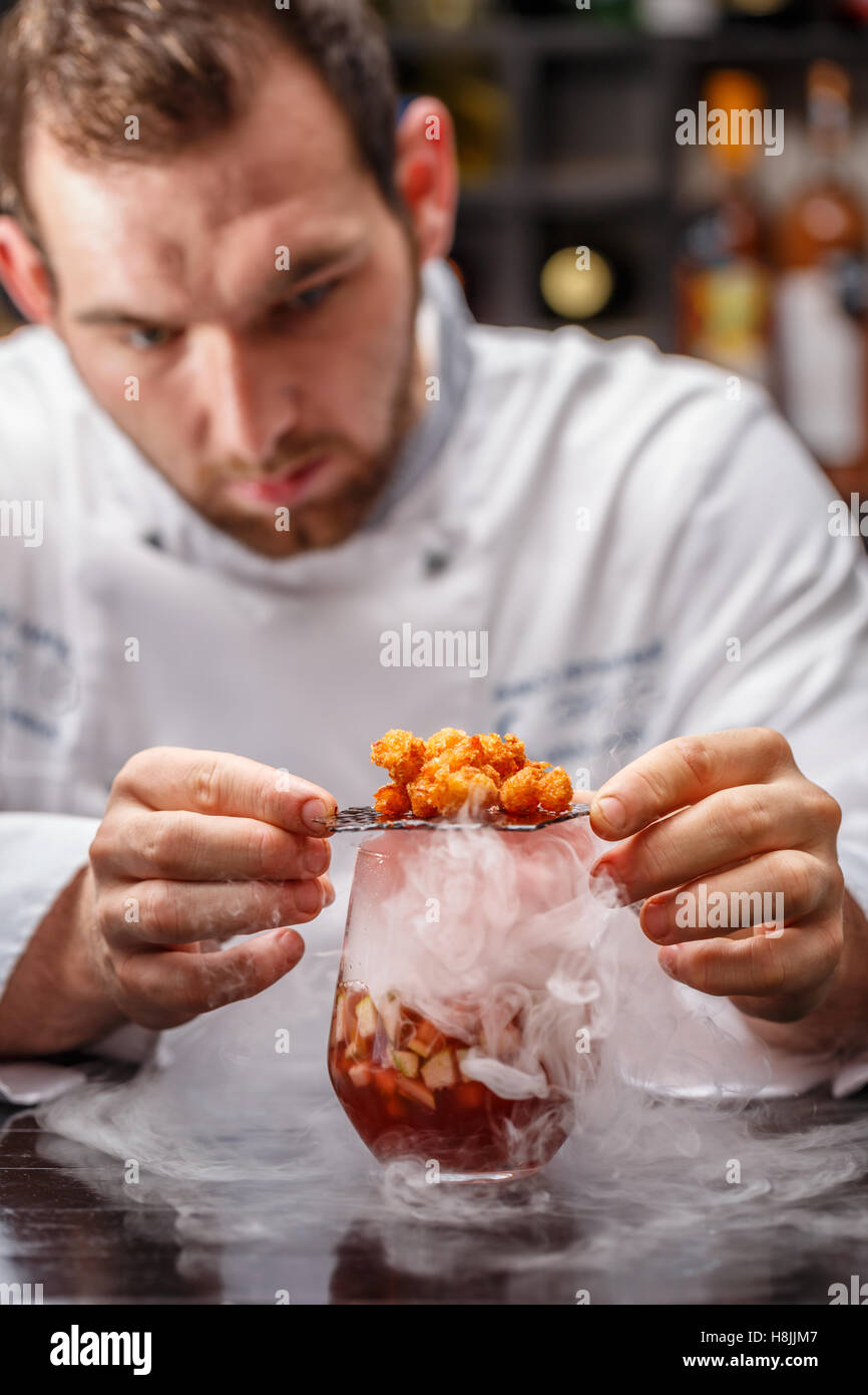Chef served gourmet smoking fruit soup Stock Photo - Alamy