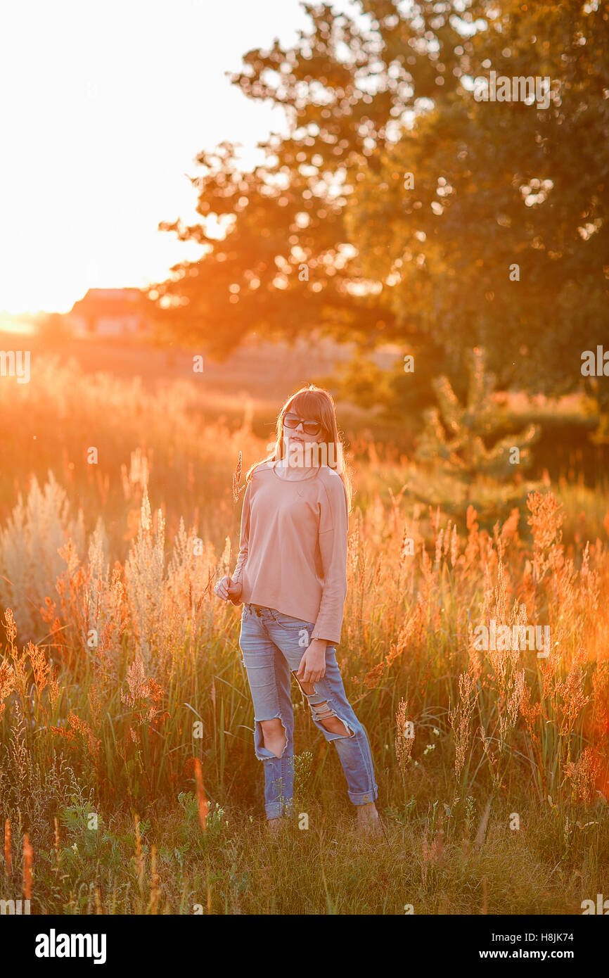 young modern girl on background sunset Stock Photo - Alamy