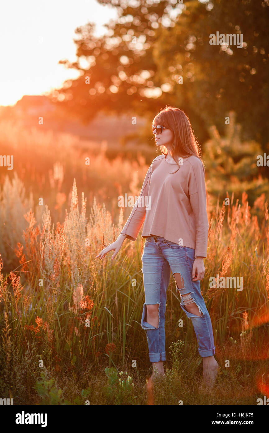 young modern girl on background sunset Stock Photo - Alamy