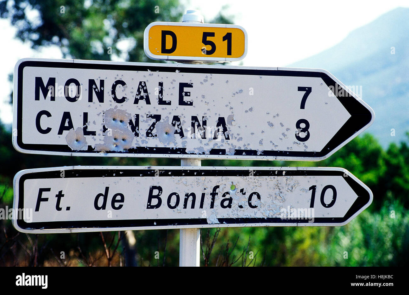 Road sign riddled with bullets in Corsica, France Stock Photo - Alamy