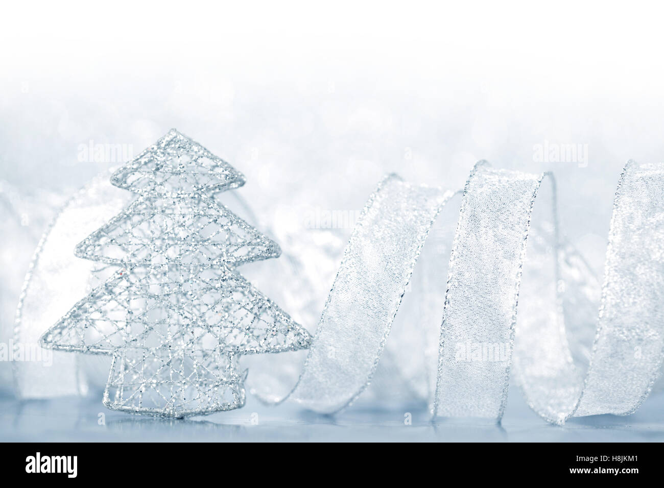 Beautiful silver decorative christmas tree on glitter background Stock ...