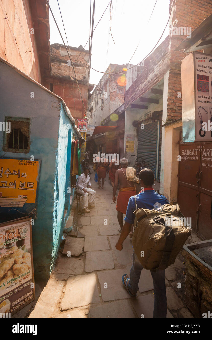 VARANASI, INDIA - 25 Oct 2016: Passerby walk through the alleyways on ...