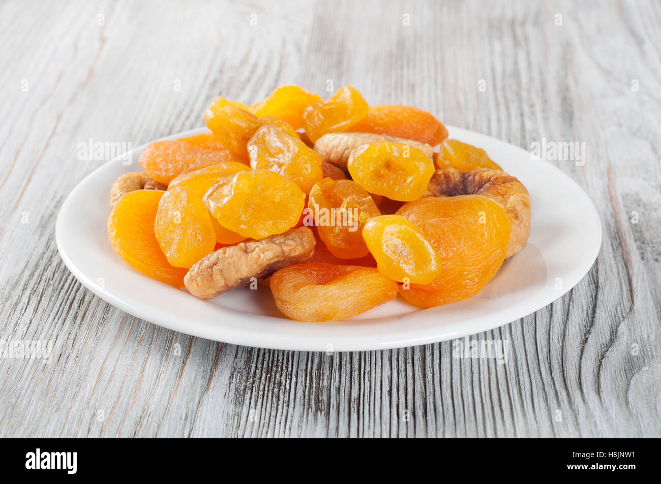 Dried fruits on a wooden background. Candied fruits, lemon, apricot ...