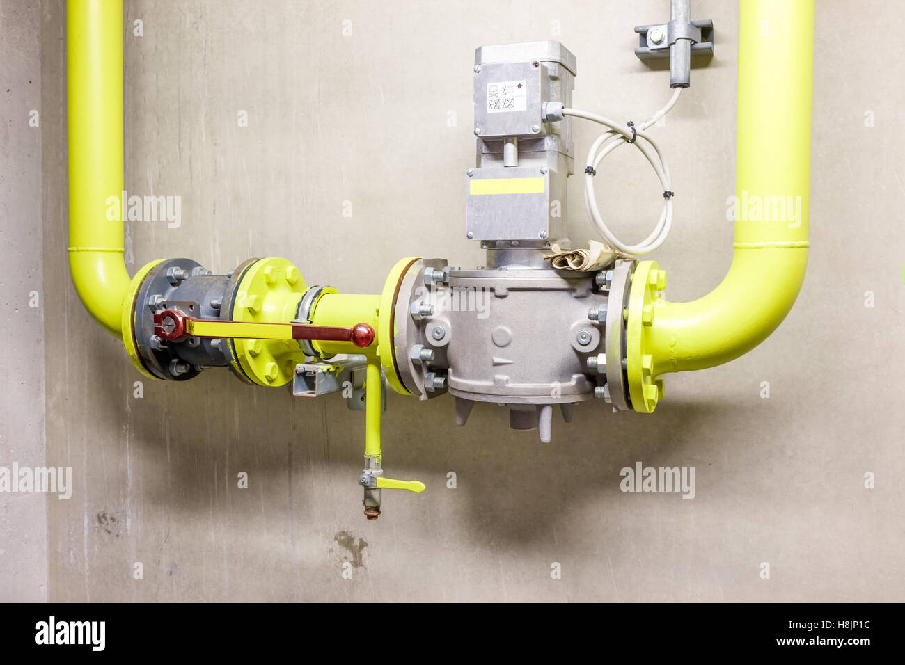 in the basement of a large building there's an industrial gas valve ...