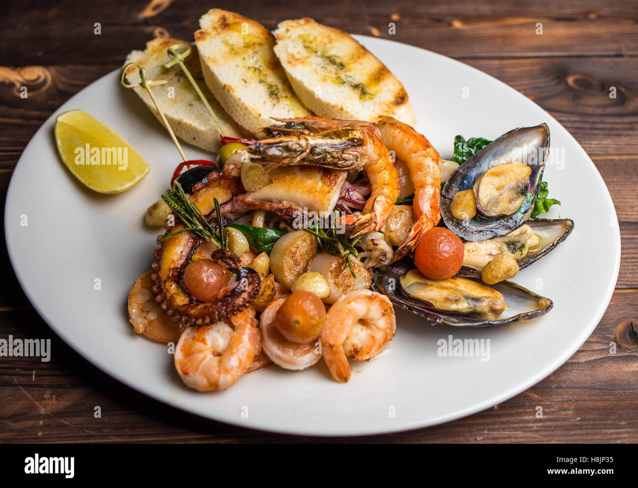 set of different seafood includes shrimp, mussels, squid and octopus ...