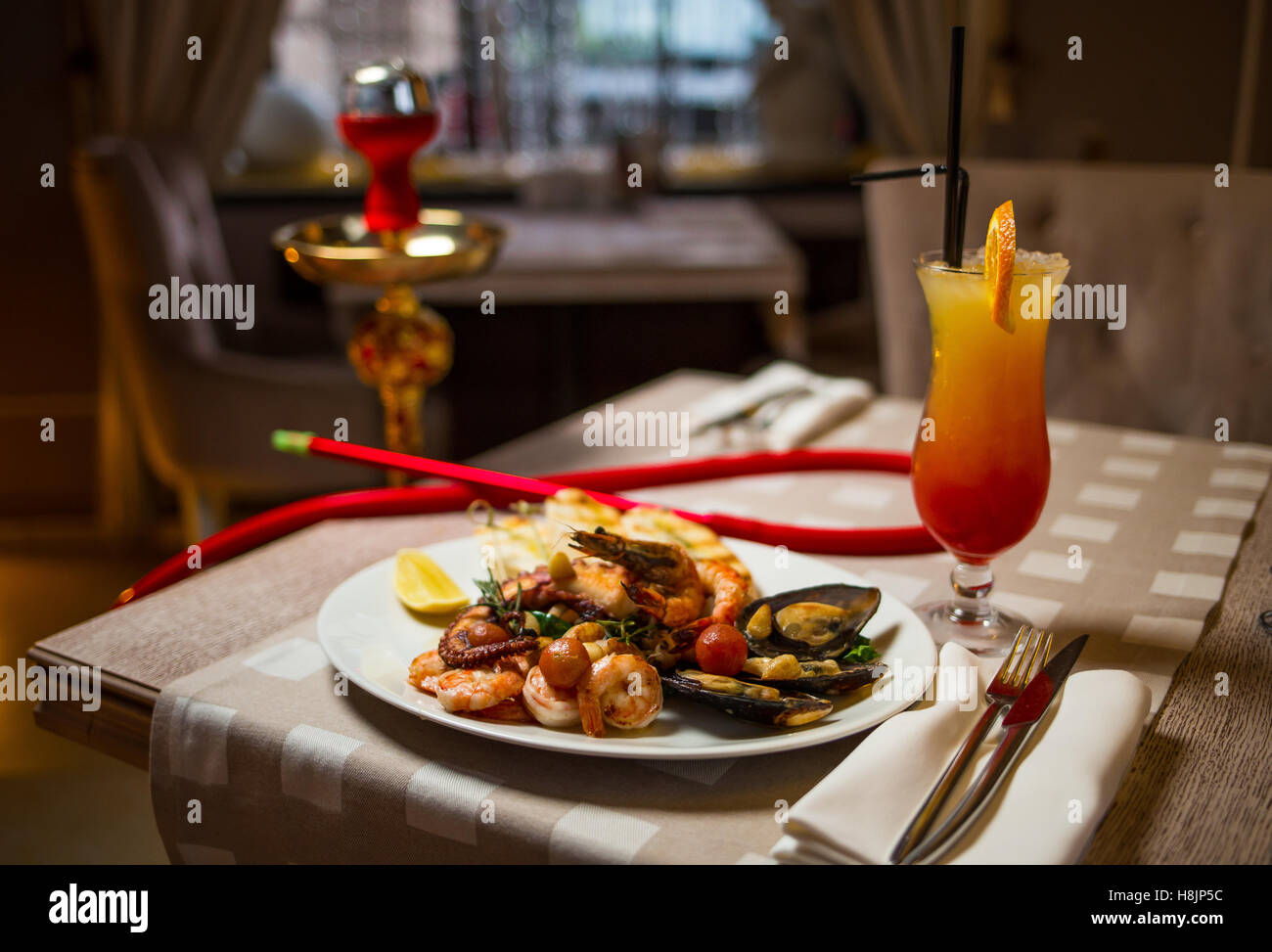 Relaxing table in a restaurant with seafood and hookah Stock Photo - Alamy