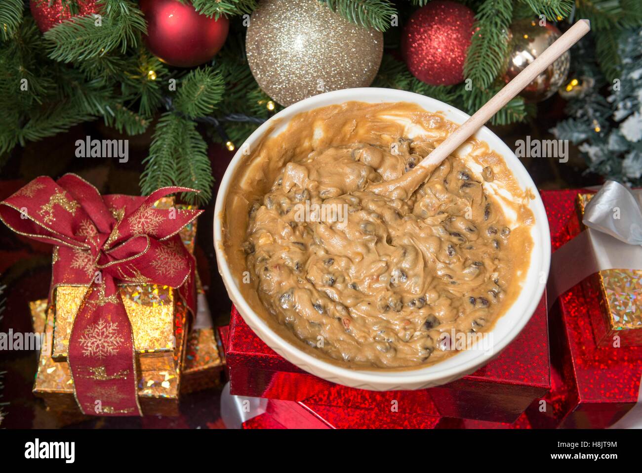 Traditional Christmas Pudding mixture being mixed in a ceramic bowl in ...