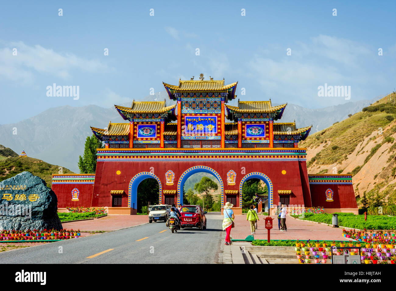 Cars and people passing thru the colorful entrance towards the Matisi ...