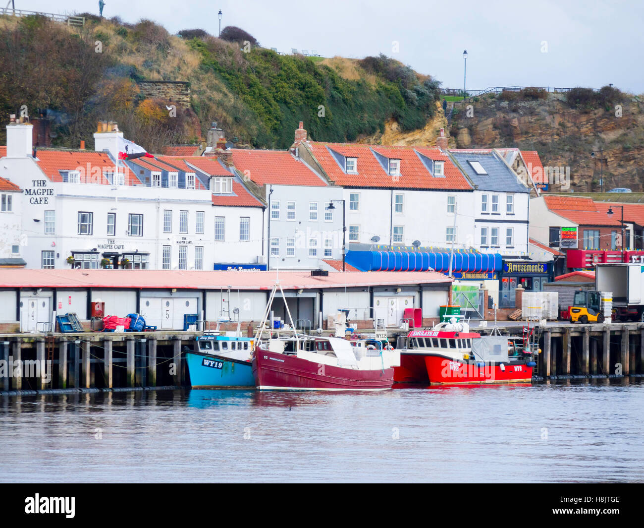 Three fishing boats tied up at the fish quay Whitby, North Yorkshire ...