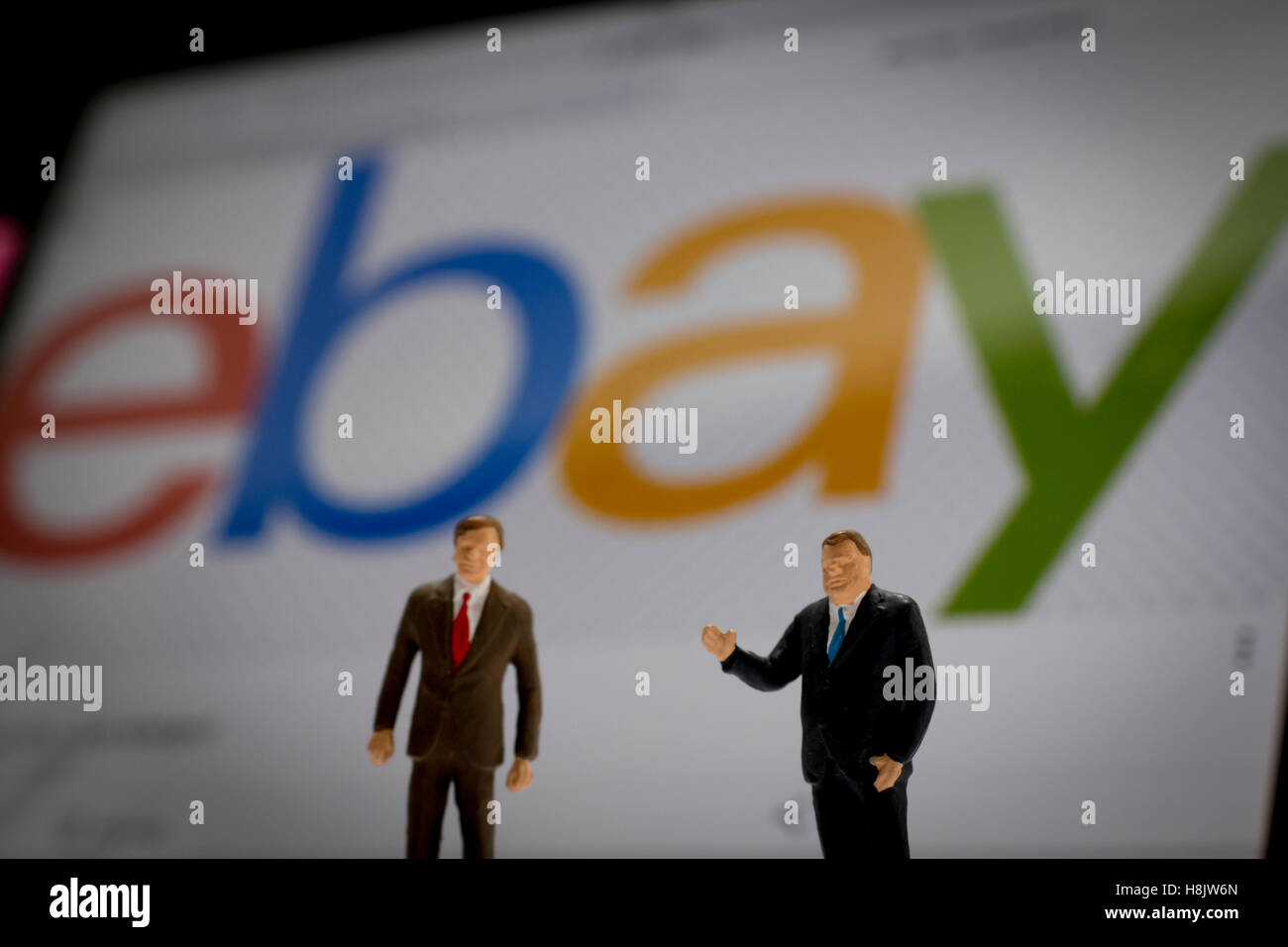 scale models of people in front of ebay logo on ipad Stock Photo - Alamy