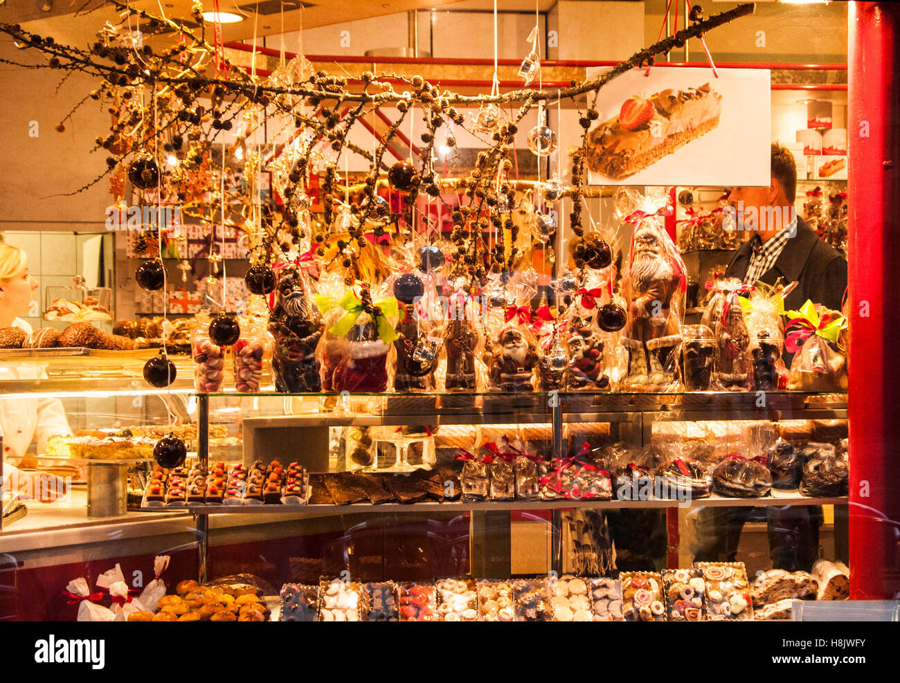 A bakery shop window showing the display of products and the customers ...
