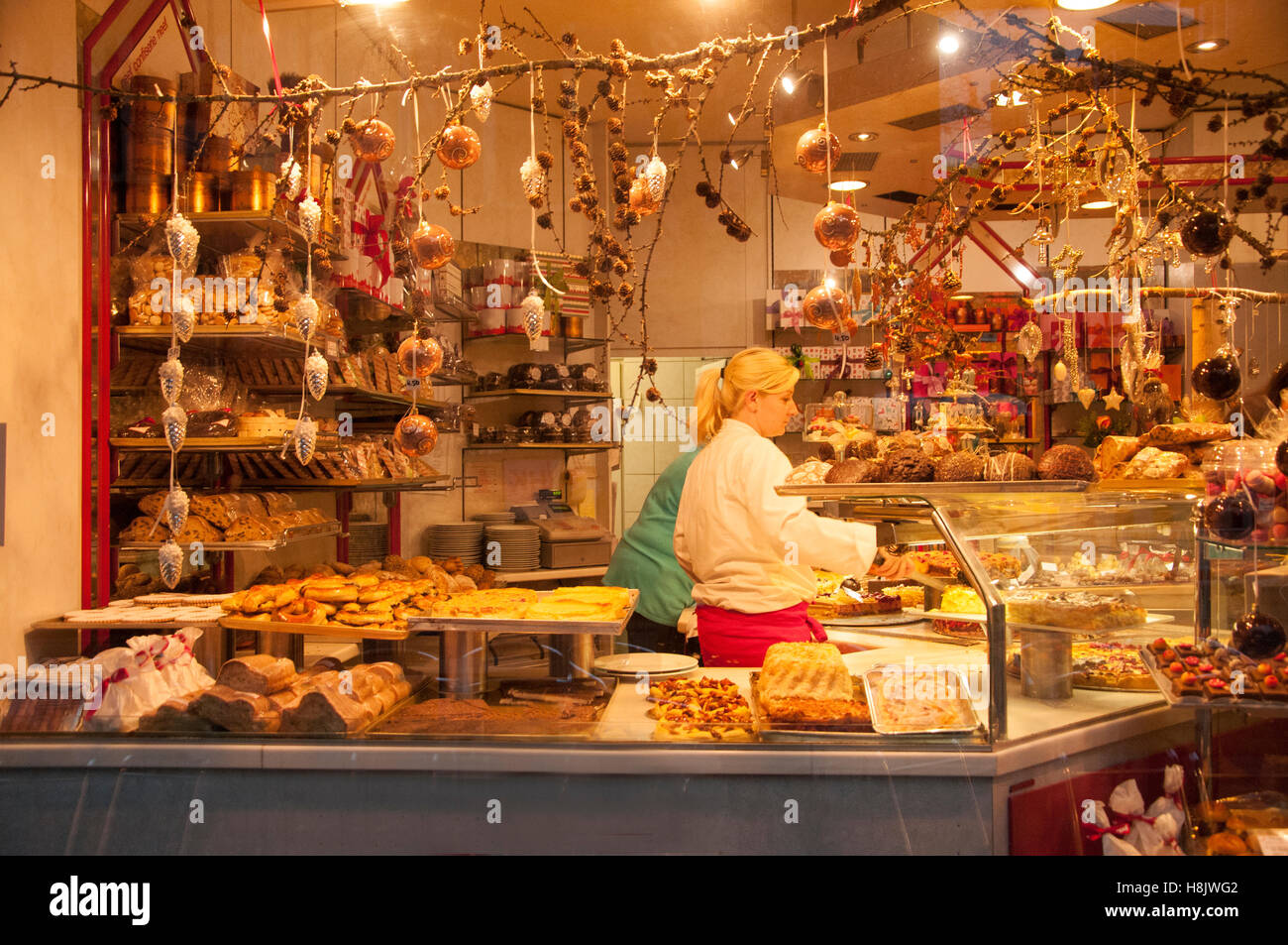 A bakery shop window showing the display of products and the workers ...