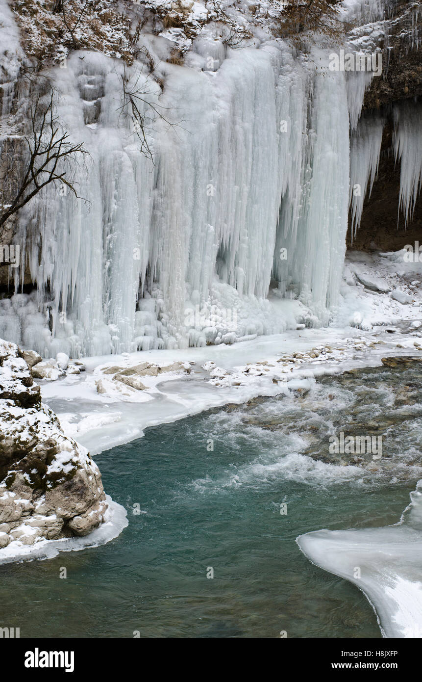 Frozen beautiful waterfall in winter. Icicles and mountain river Stock ...