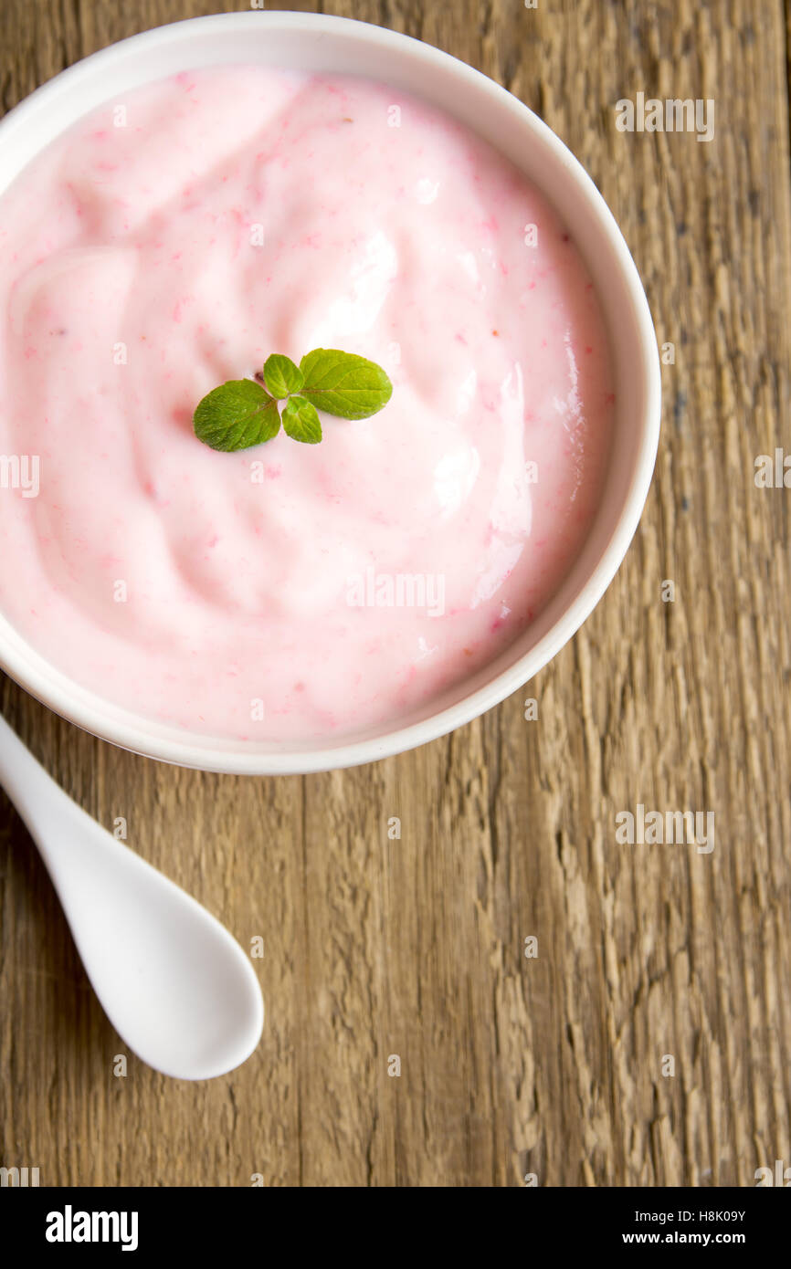 Strawberry yogurt with mint on wooden white background. strawberry ...