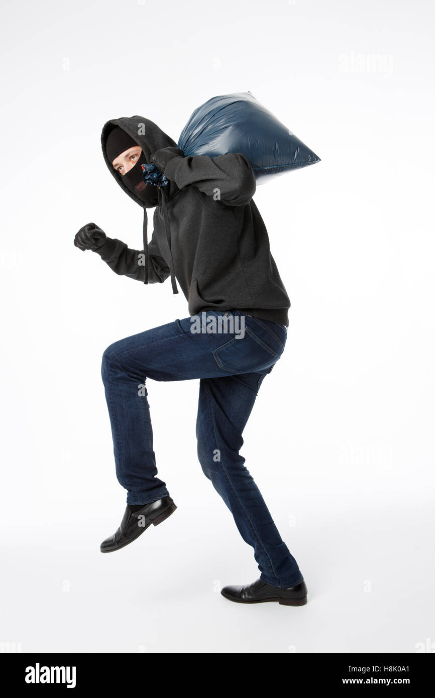 Thief slinking with blue bag on pure white background Stock Photo - Alamy