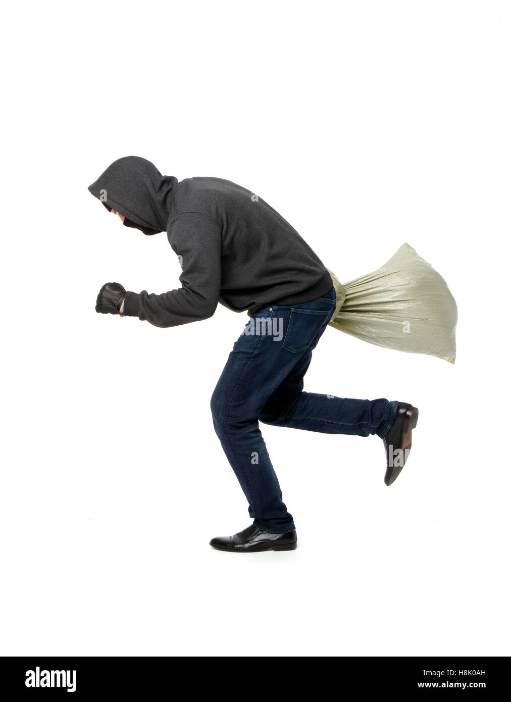 Thief flees with gray sack on blank white background Stock Photo - Alamy