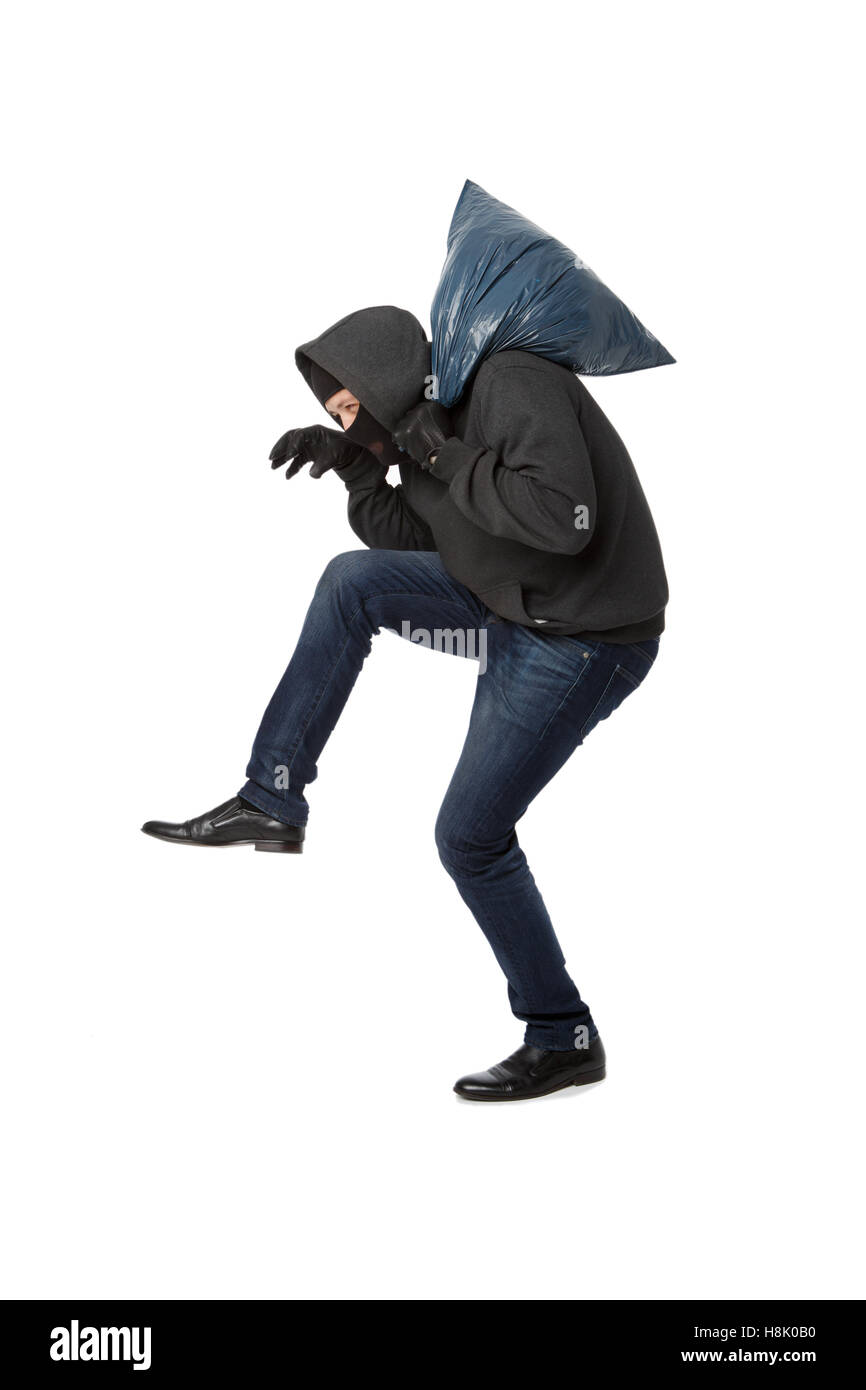 Robber sneaks with blue bag on his shoulder on blank white background ...