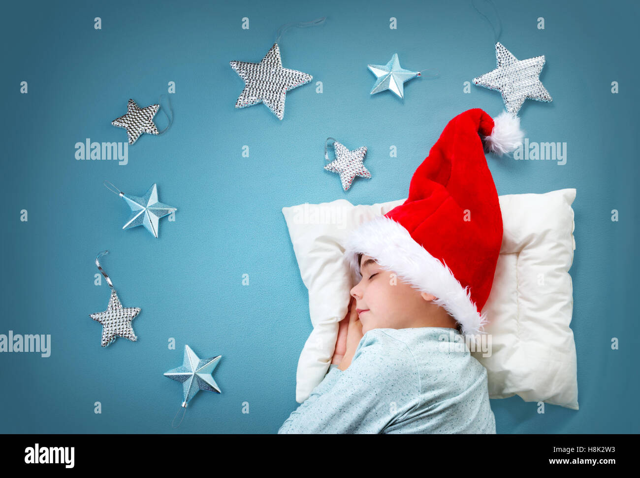 Sleepy baby on red blanket Stock Photo - Alamy
