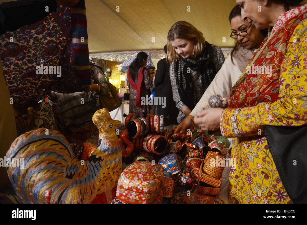Lahore, Pakistan. 13th Nov, 2016. Pakistani visitors taking interest in ...