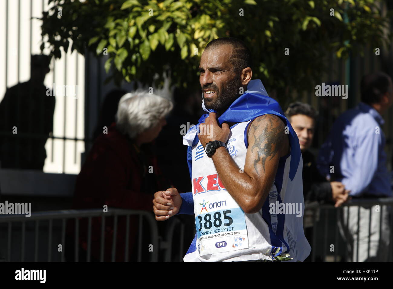 Athens, Greece. 13th Nov, 2016. A runner carries a greek flag ...