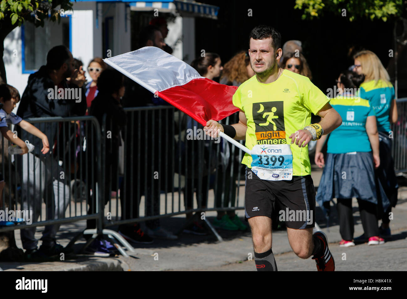 Athens, Greece. 13th Nov, 2016. A runner carries a Polish flag ...