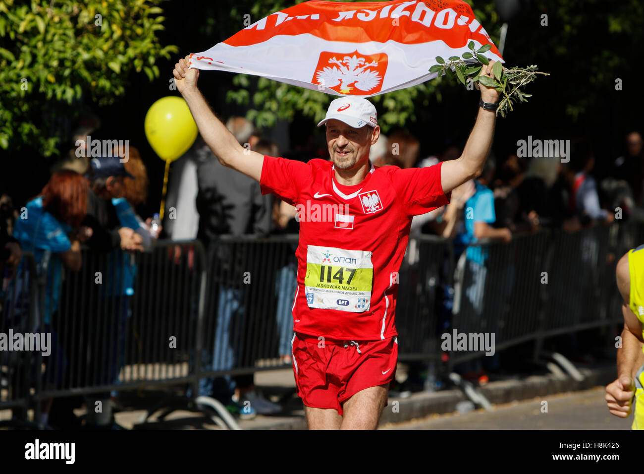 Athens, Greece. 13th Nov, 2016. A runner carries a Polish flag ...