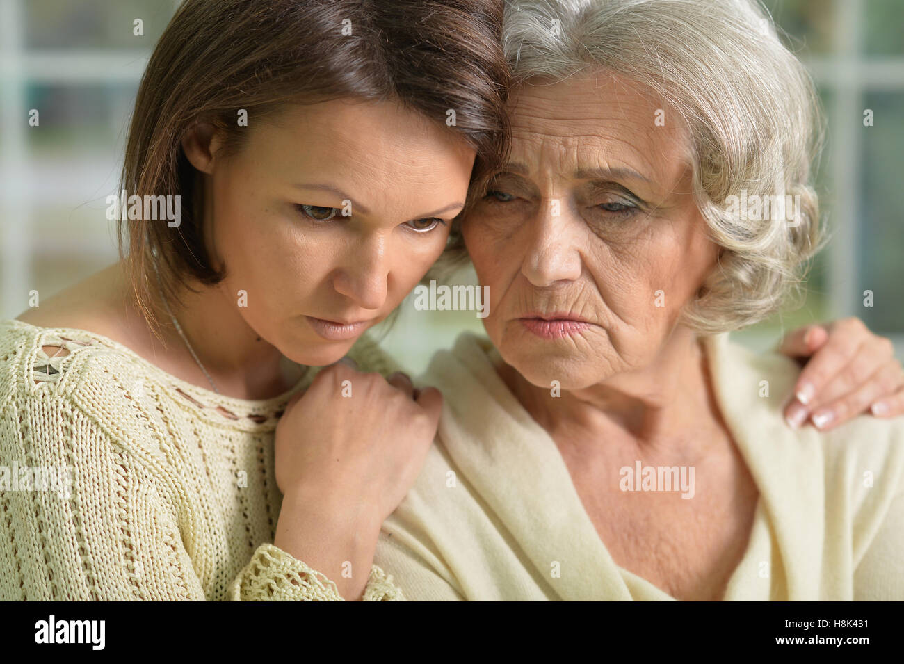 Sad senior and young women Stock Photo - Alamy