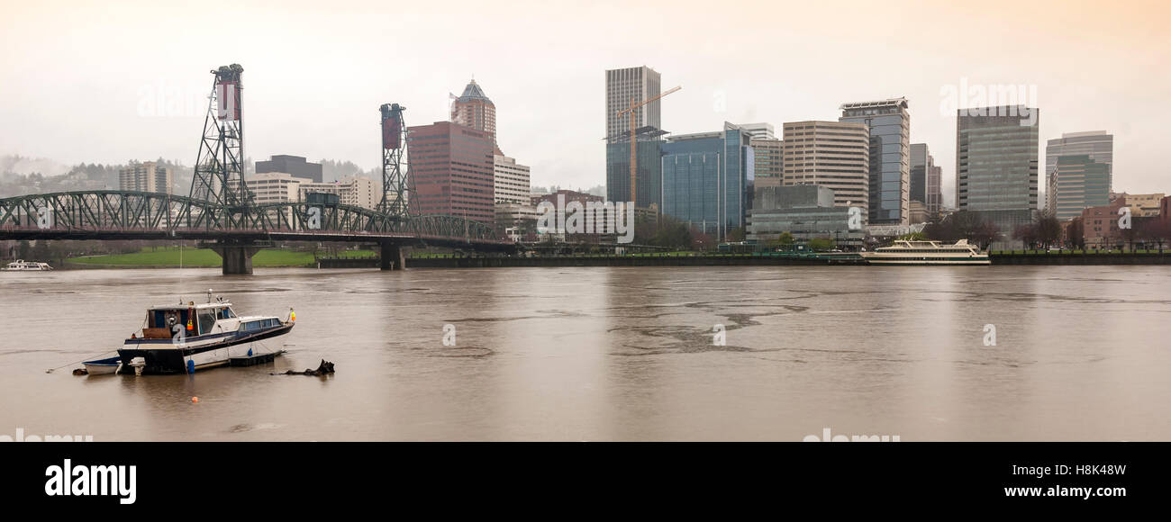 Boat floats in a river with the Portland Oregon skyline Stock Photo - Alamy