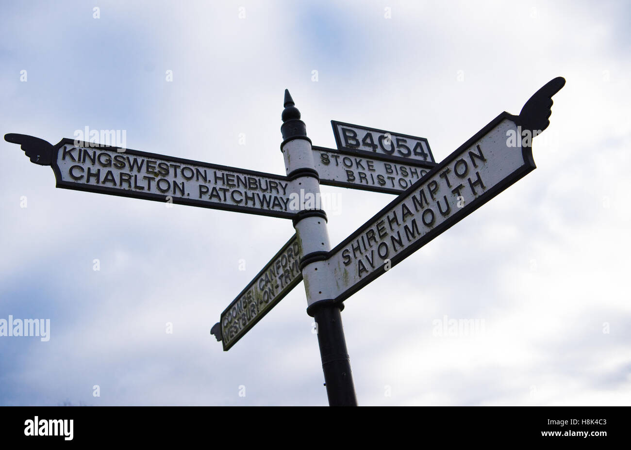 Traditional English black and white four-way fingerpost road sign ...