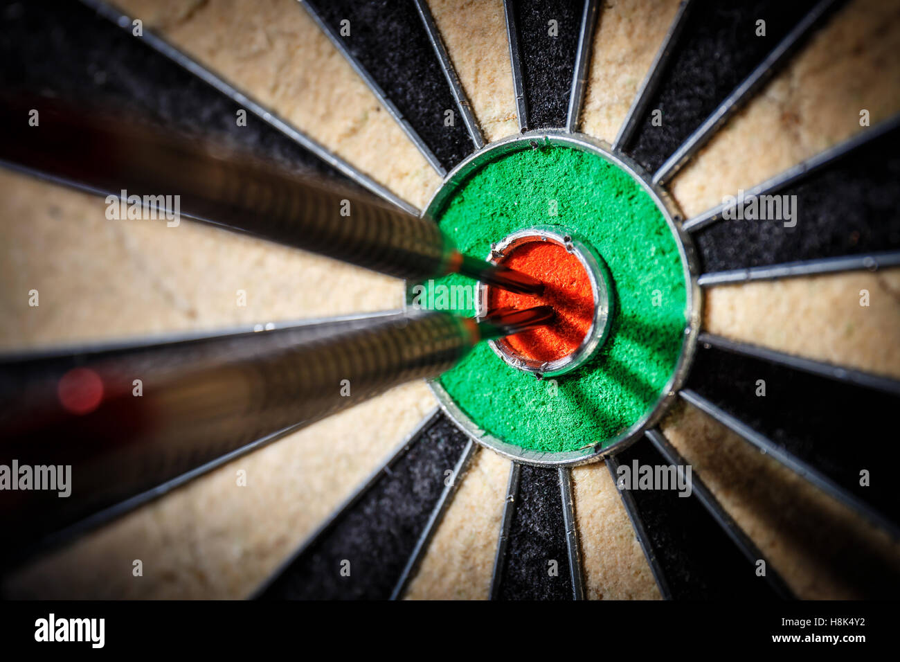 three darts in bull's eye, close up Stock Photo - Alamy