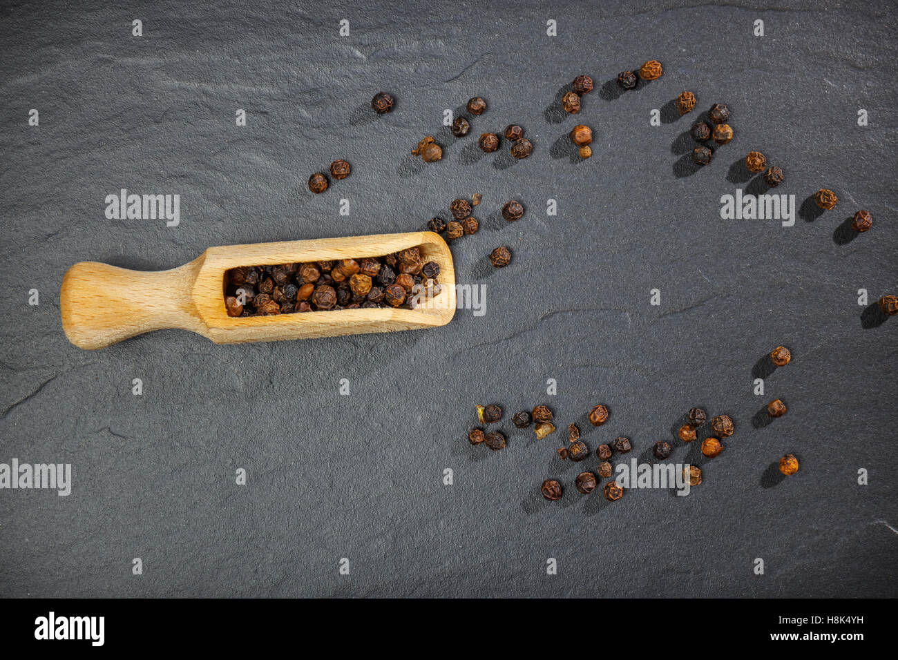 black pepper on rustic stone background. Overhead view food photography ...