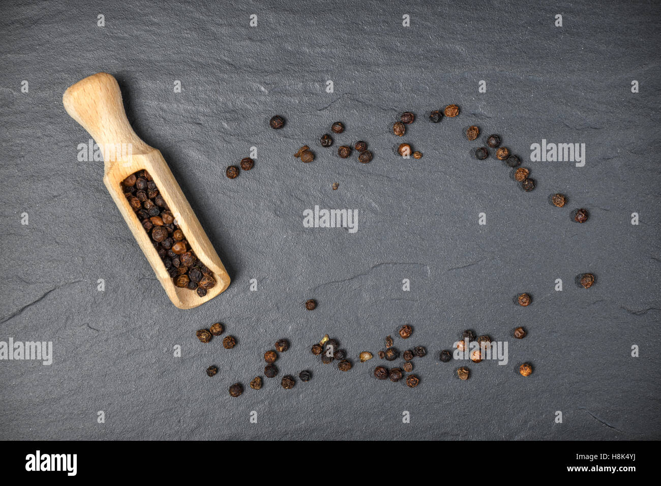 black pepper on rustic stone background. Overhead view food photography ...