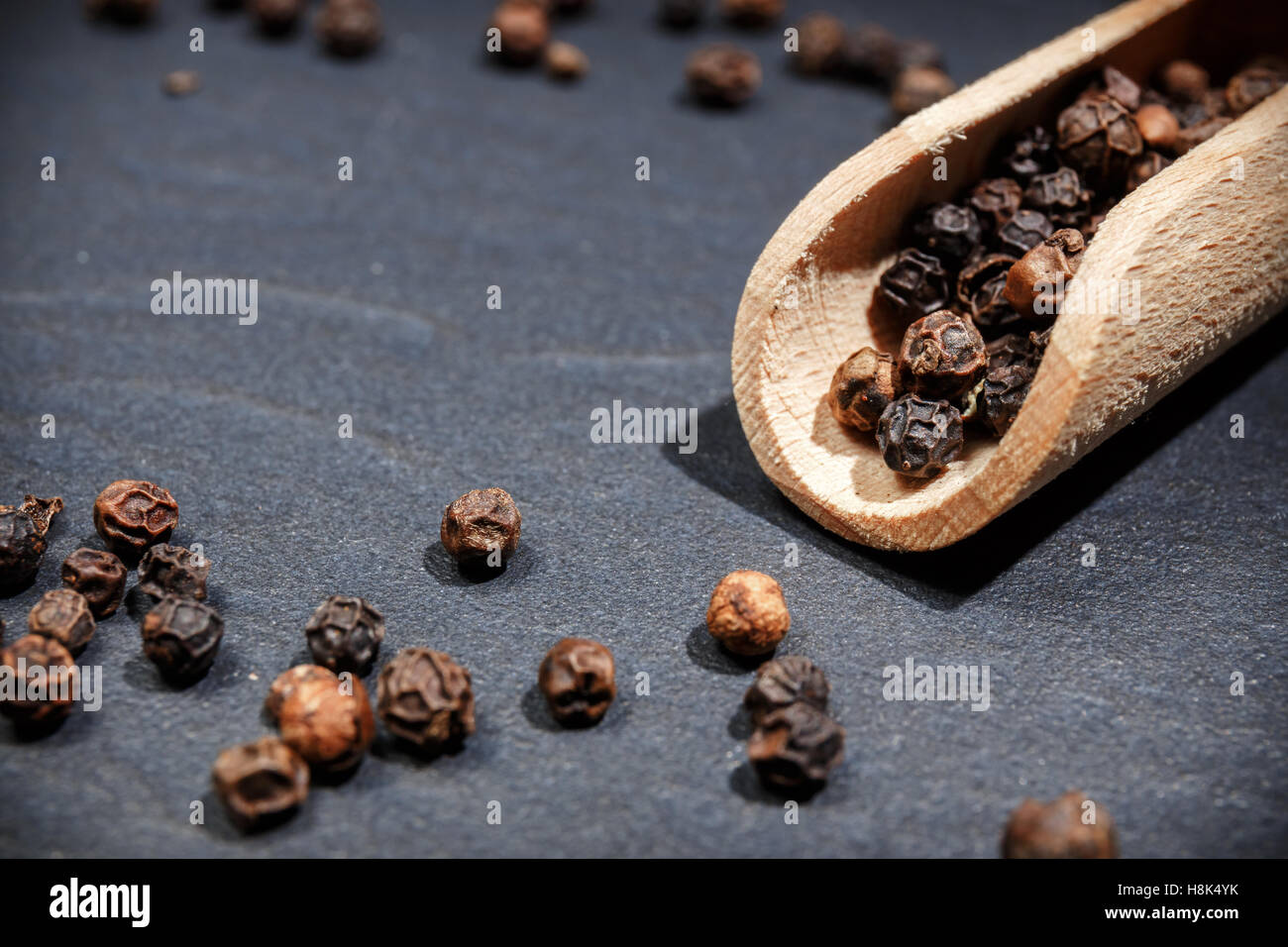 black pepper on rustic stone background. Overhead view food photography ...