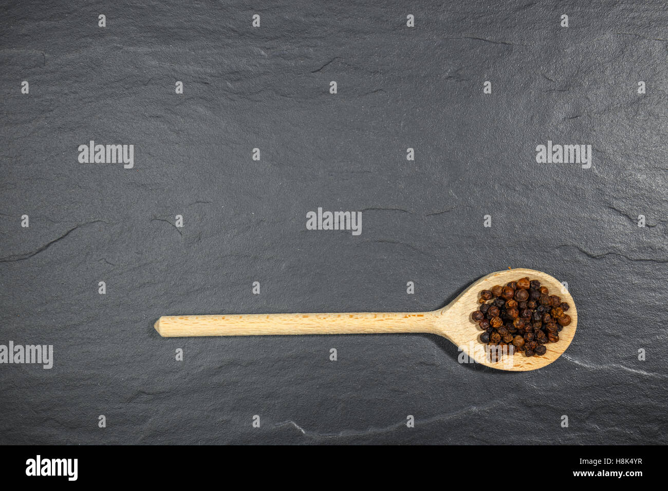 black pepper on rustic stone background. Overhead view food photography ...