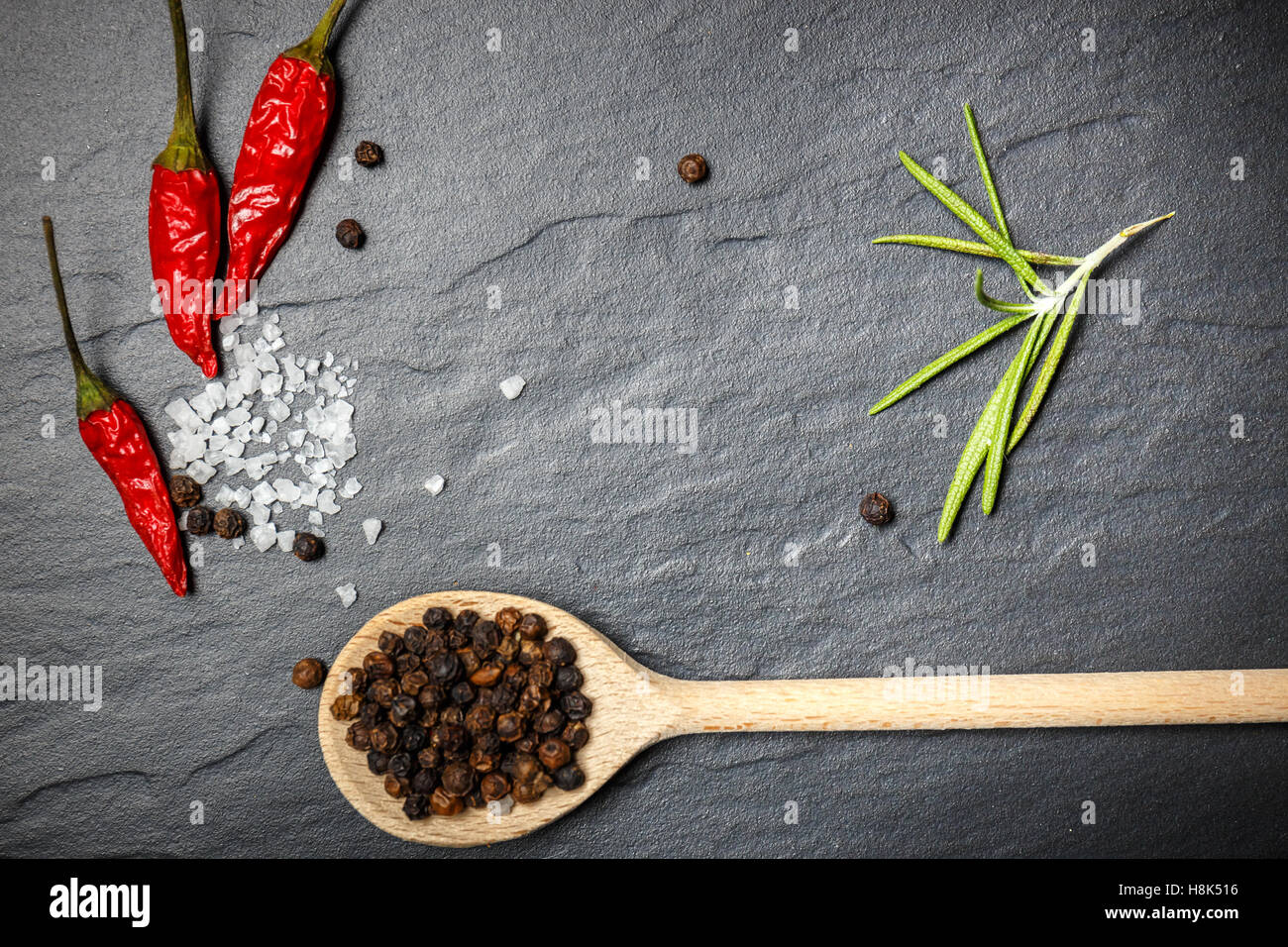 Chili with black pepper and salt on rustic stone background. Overhead ...