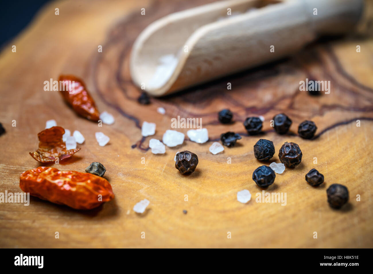 Chili with black pepper and salt on rustic wooden table. Overhead view ...