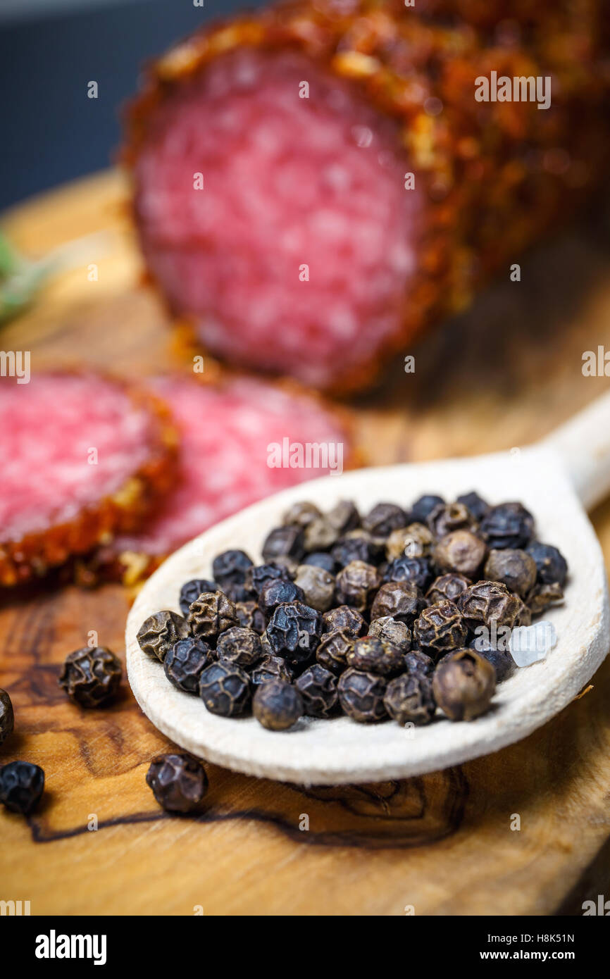 dried salami crusted in ground red pepper on dark background Stock ...