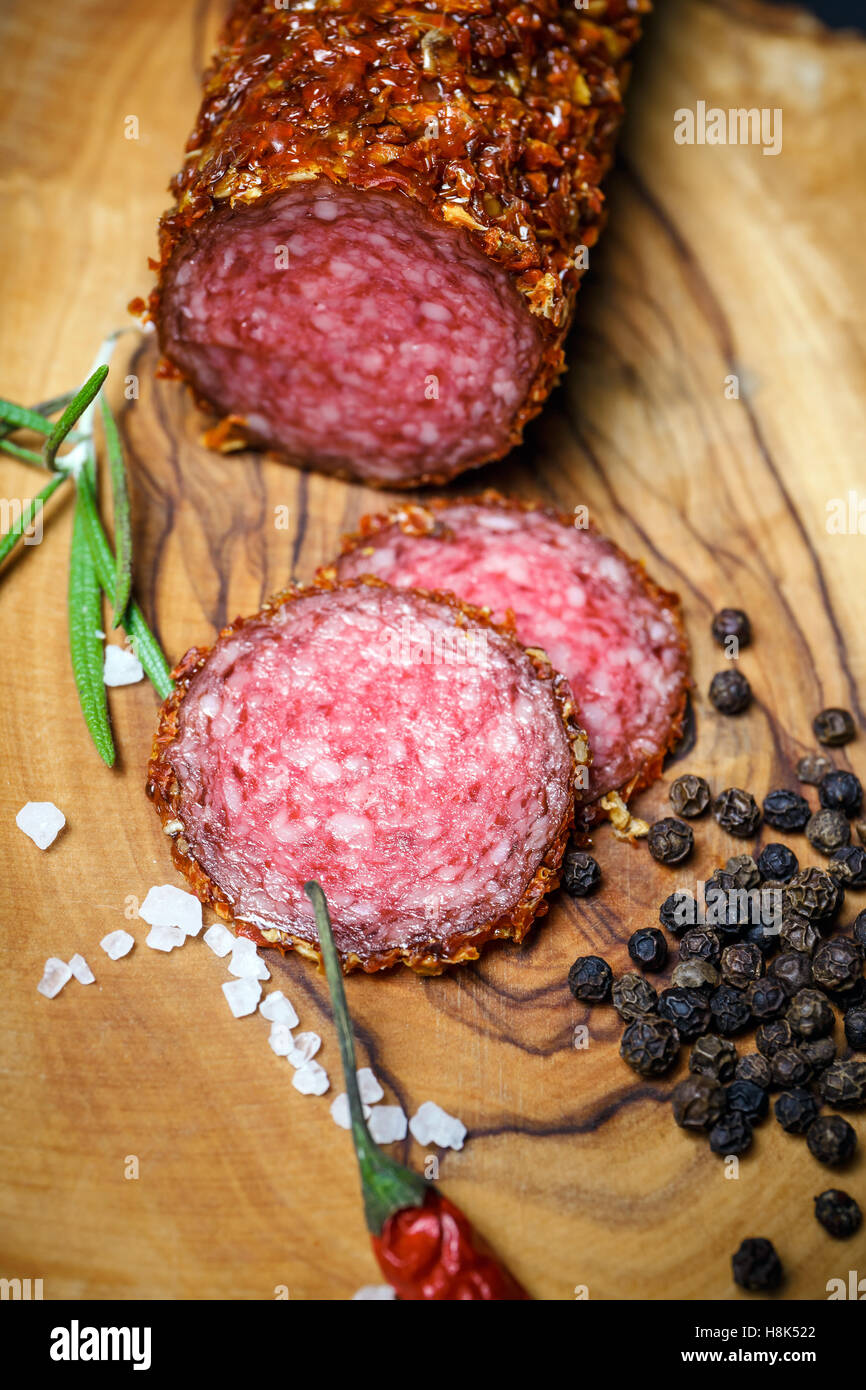dried salami crusted in ground red pepper on dark background Stock ...