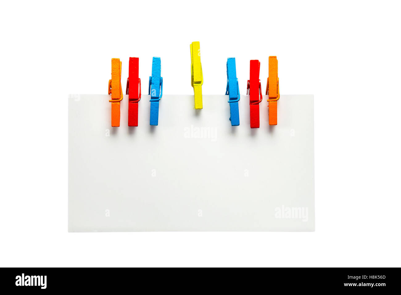 close up of a note paper and clothes pegs isolated on white background ...