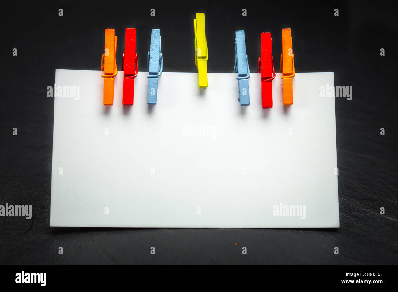 close up of a note paper and clothes pegs on a black background Stock ...