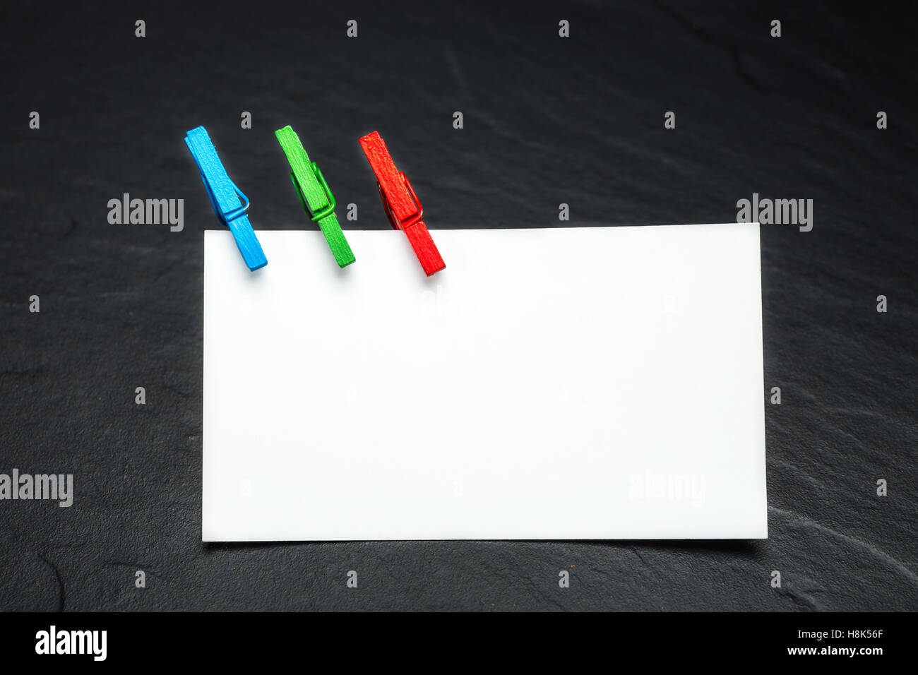 close up of a note paper and clothes pegs on a black background Stock ...