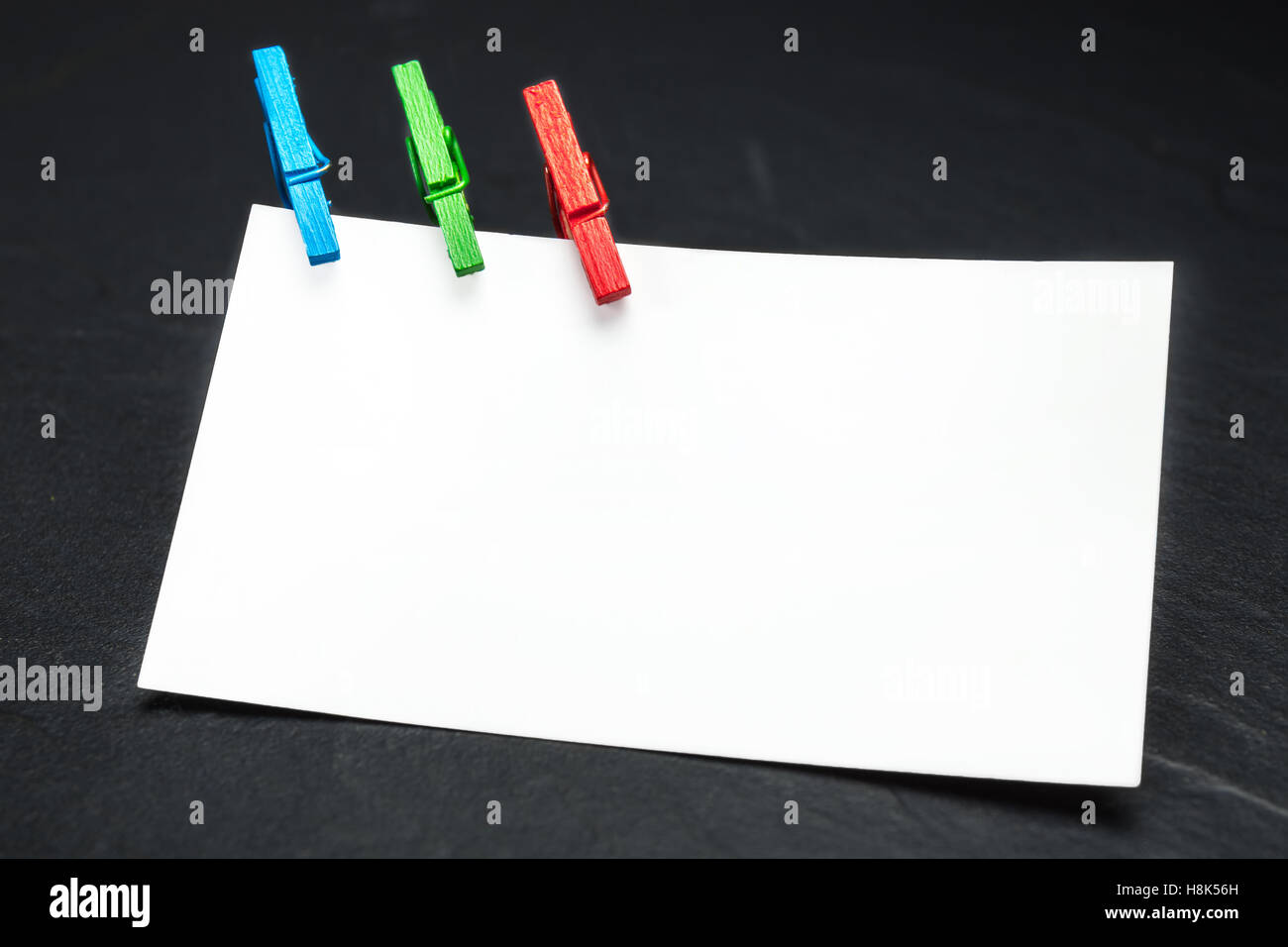 close up of a note paper and clothes pegs on a black background Stock ...