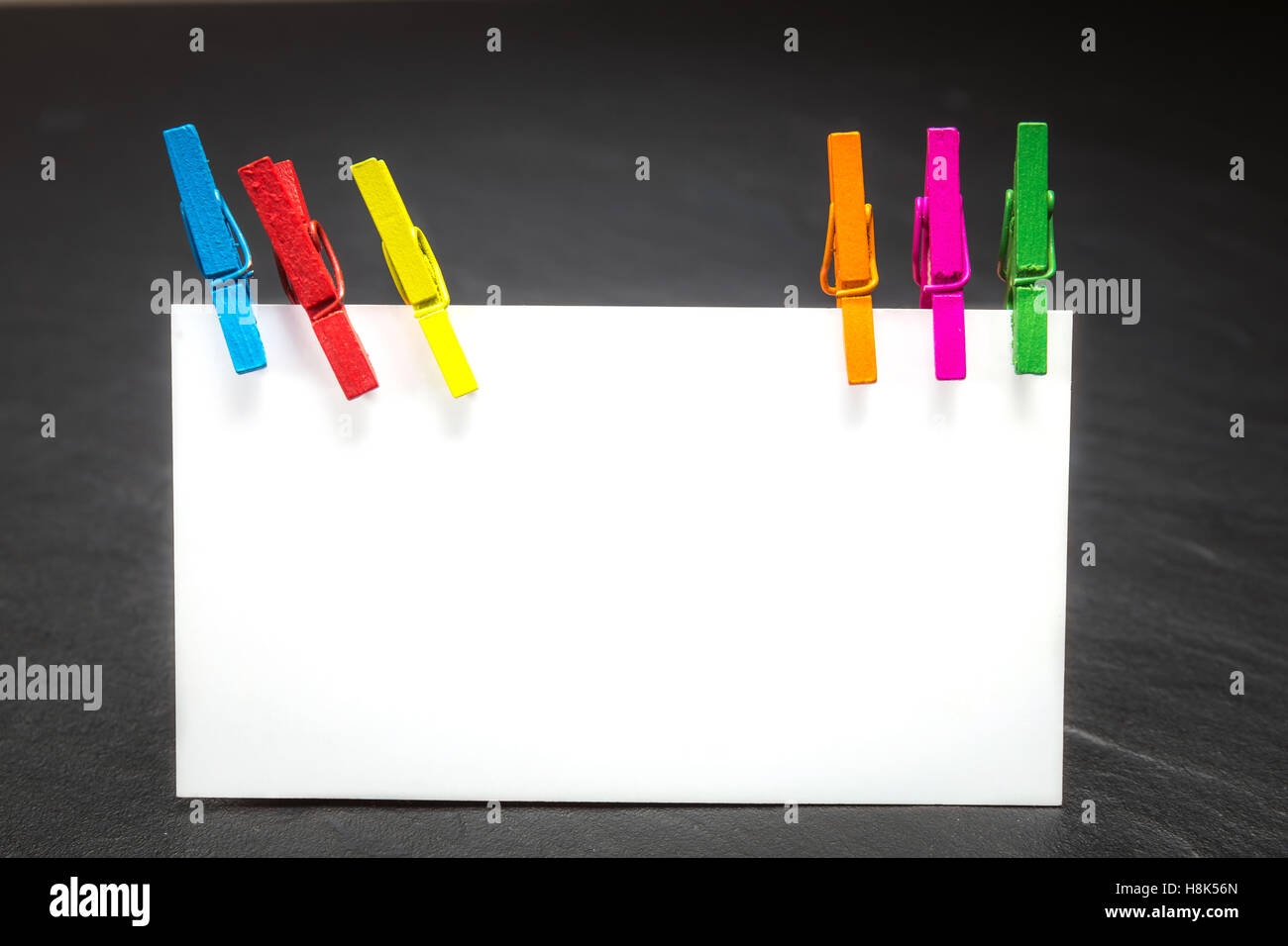 close up of a note paper and clothes pegs on a black background Stock ...